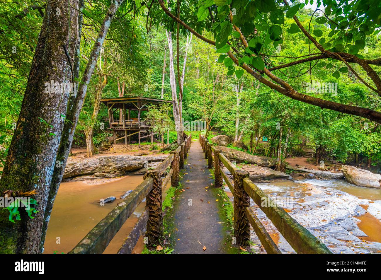Wooden bridge above the Mae Sa river, near the waterfall, Thailand. Old ...