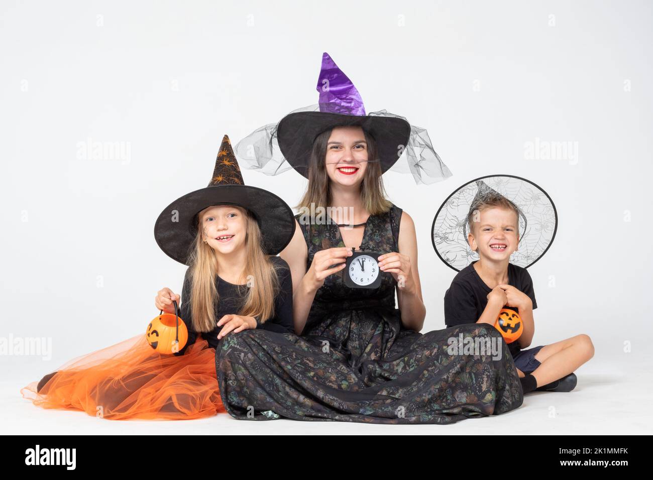 Family Halloween. A happy family, a mother and children in creepy witch ...