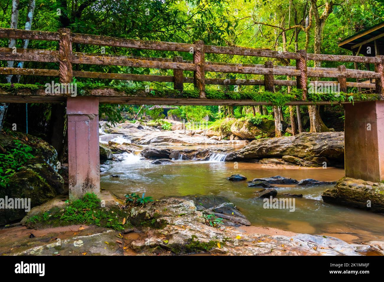Wooden bridge above the Mae Sa river, near the waterfall, Thailand. Old ...
