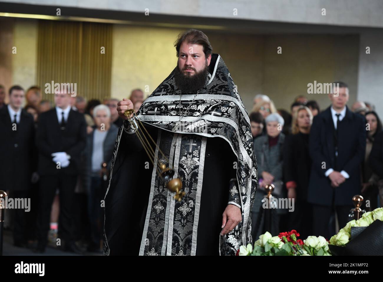 Moscow. The priest during the burial service of the CEO of media group ...