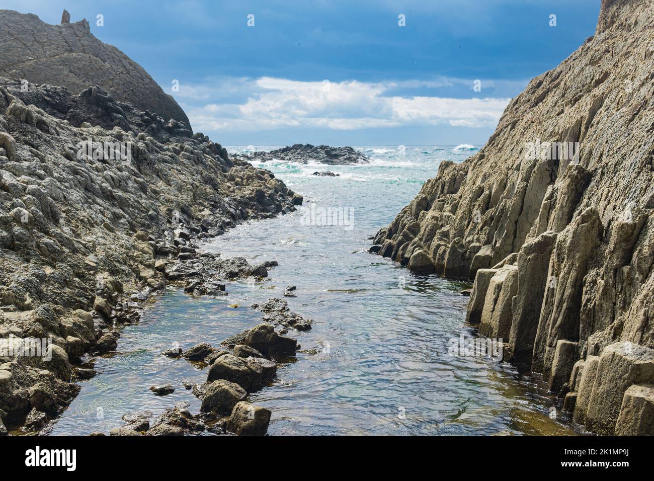 coastal cliffs formed by columnar basalt at low tide Stock Photo - Alamy