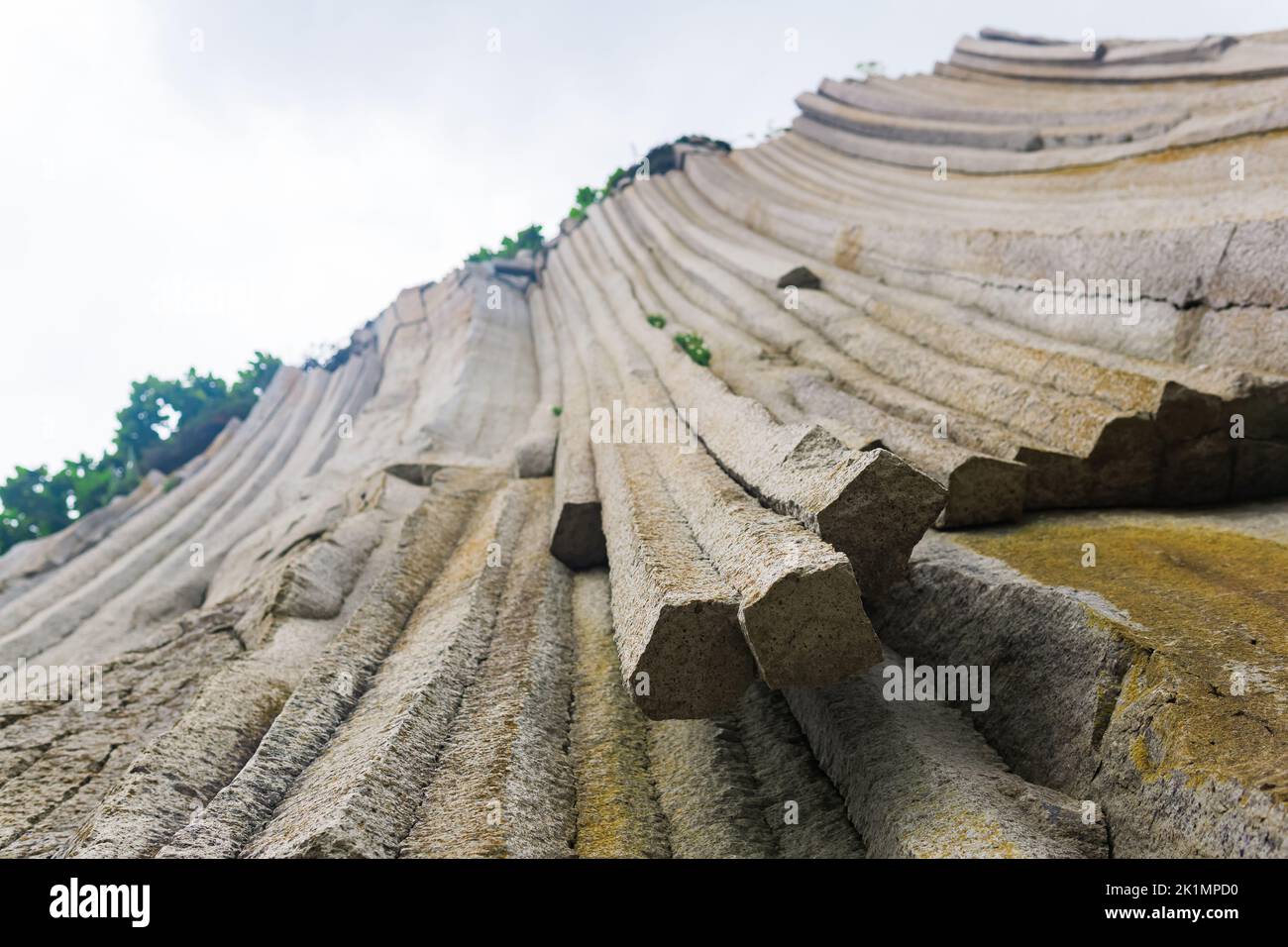 basalt columns forming a coastal rock at Cape Stolbchaty on Kunashir ...
