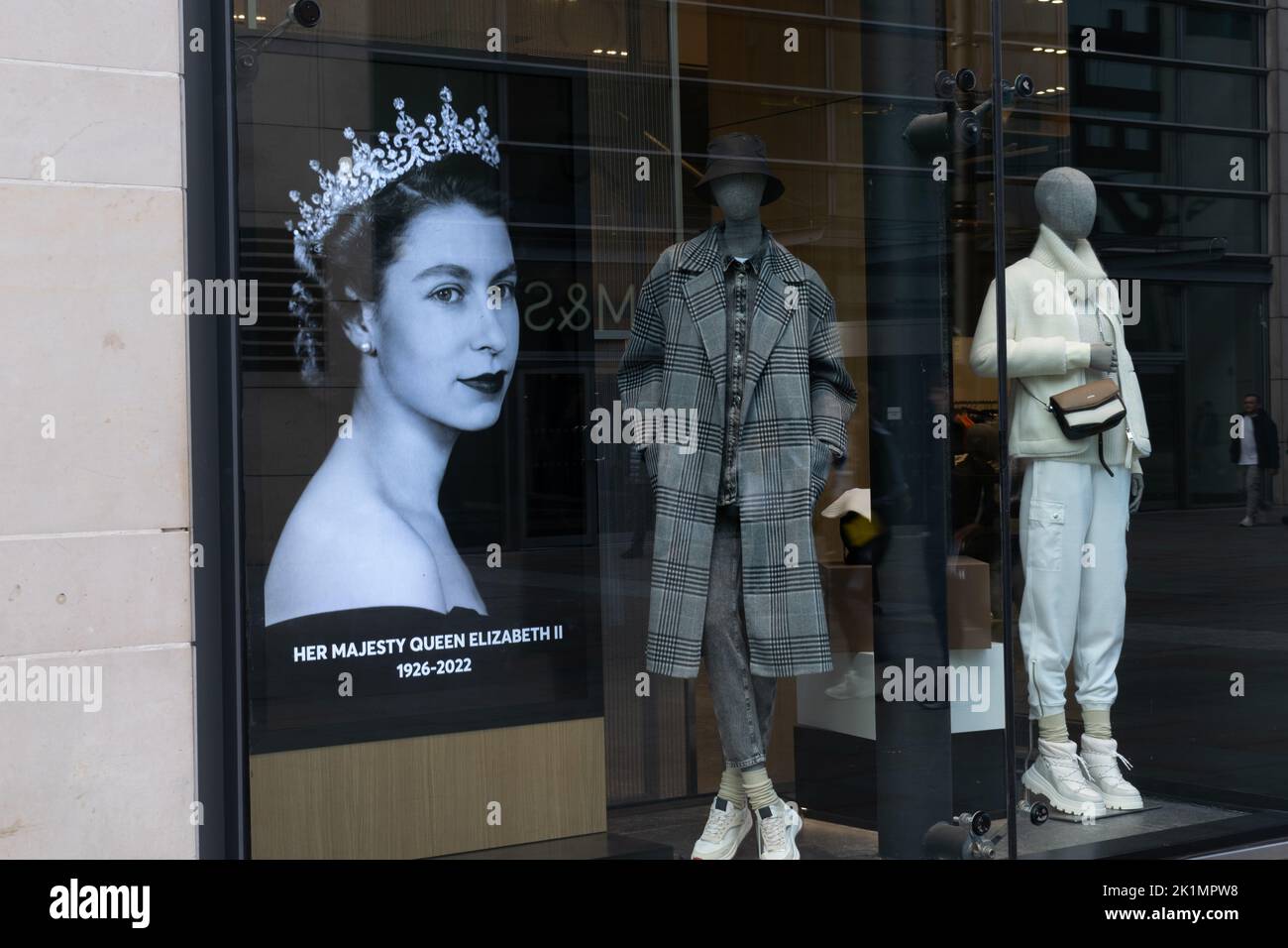 Shop window display with portrait of Queen Elizabeth II and mannequin ...