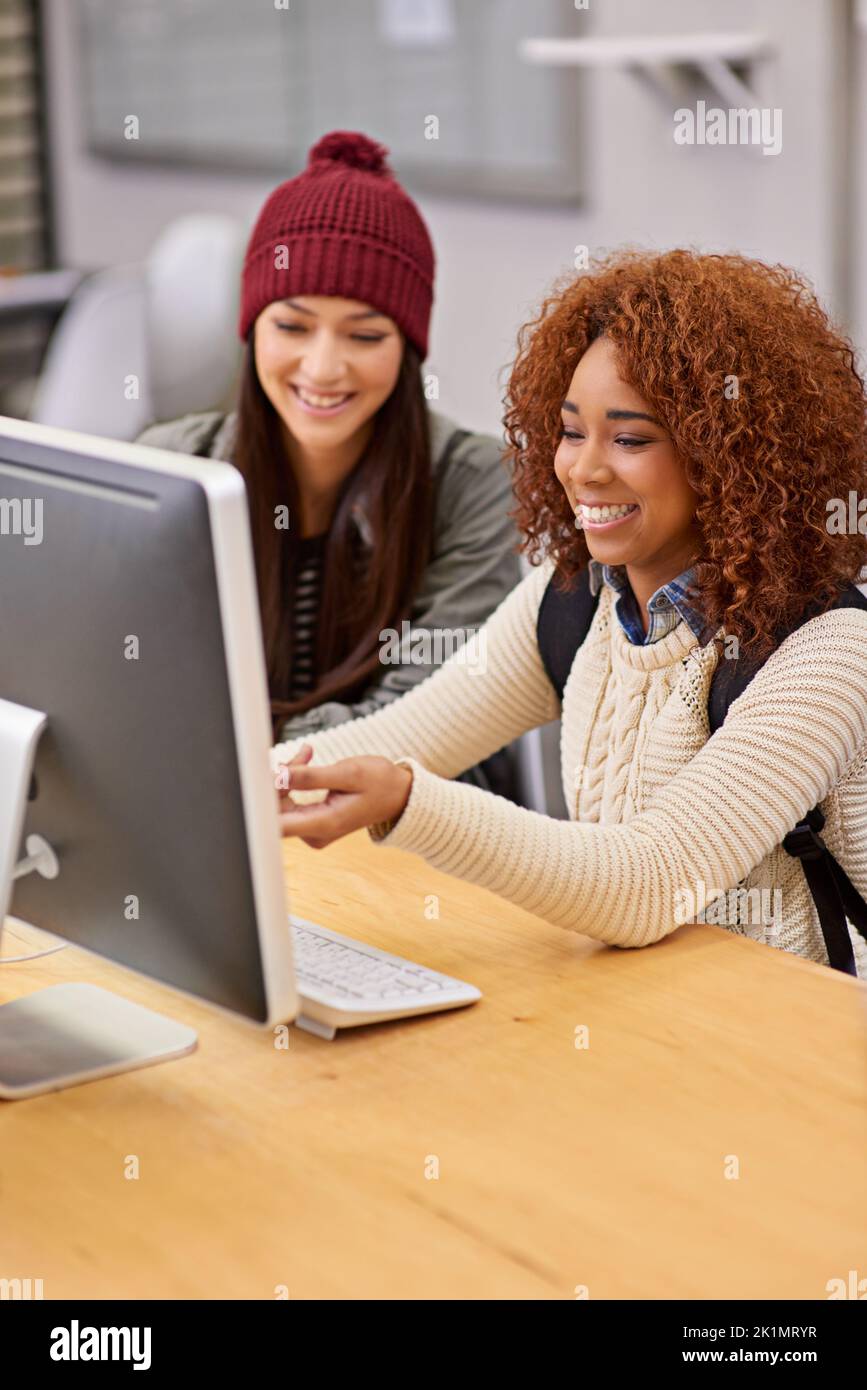 Using online resources to their advantage. two female students studying ...