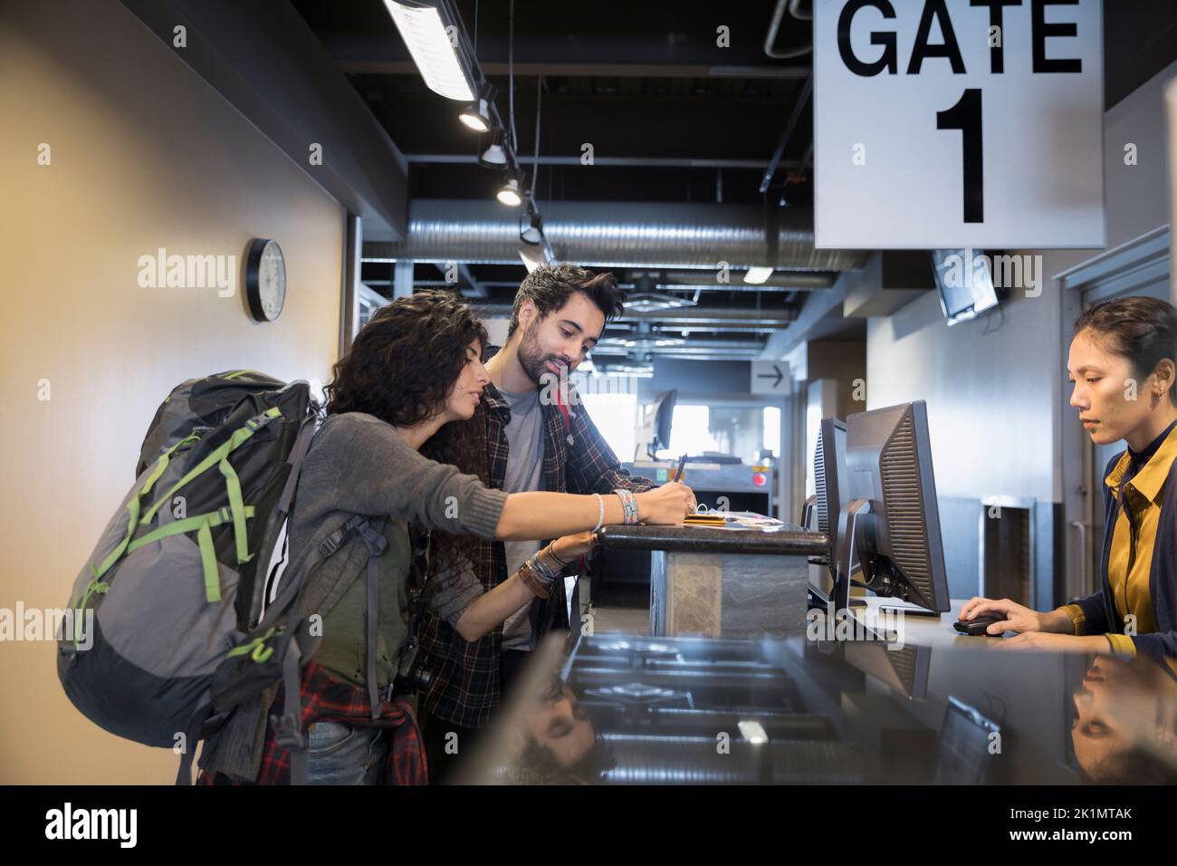 Woman checking in passenger hi-res stock photography and images - Alamy