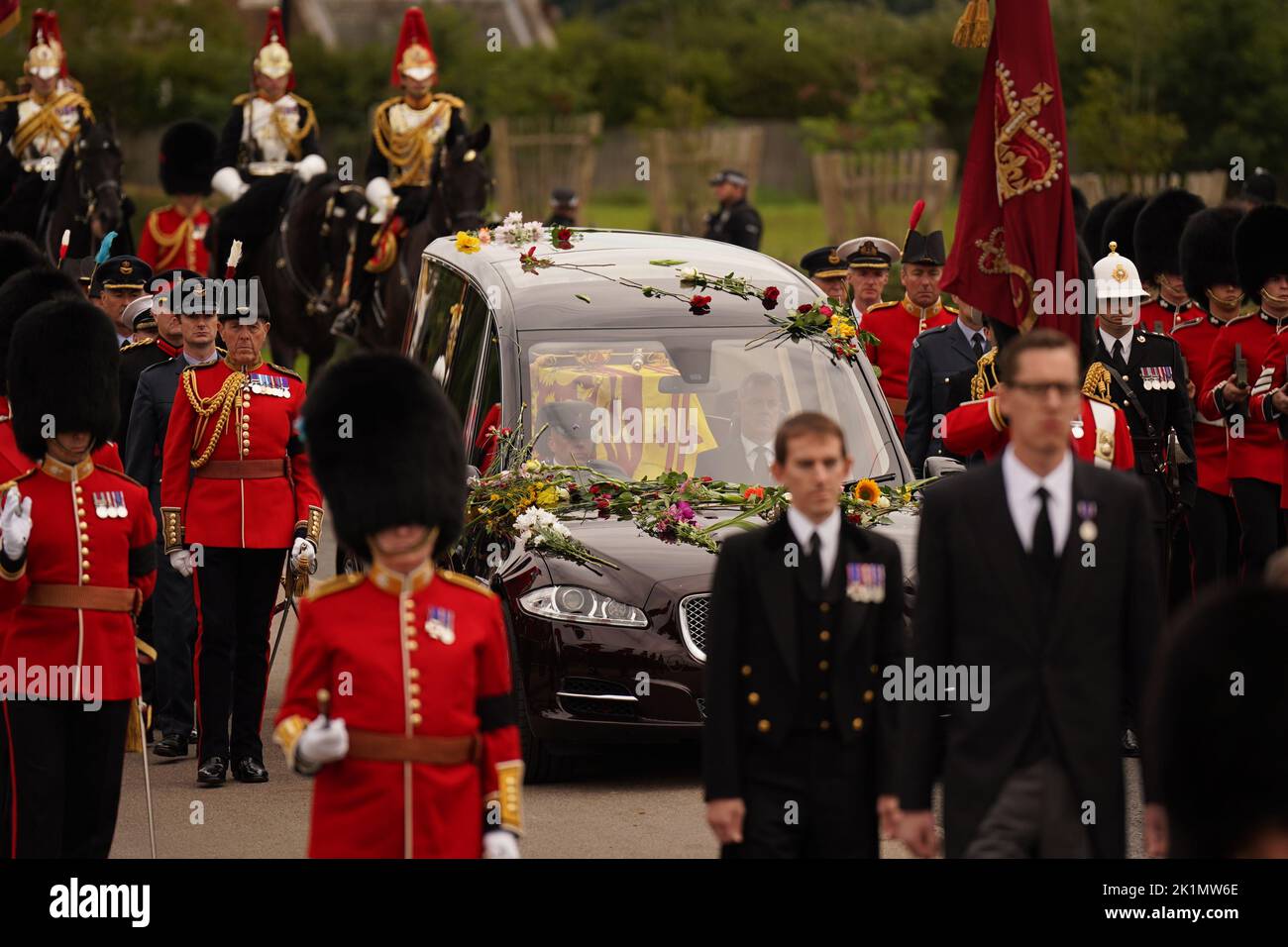 The State Hearse carrying the coffin of Queen Elizabeth II, draped in the Royal Standard with ...