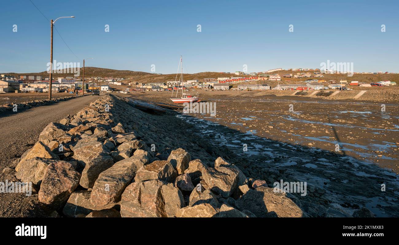 Low tide with a distant view of the skyline of the city of Iqaluit in ...