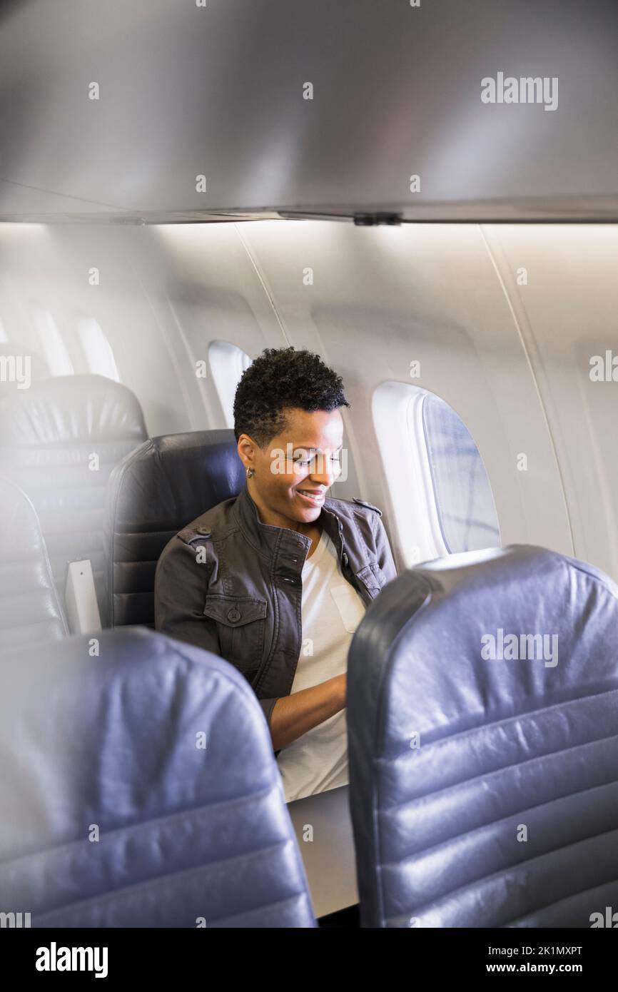 Airplane woman smile traveler hi-res stock photography and images - Alamy