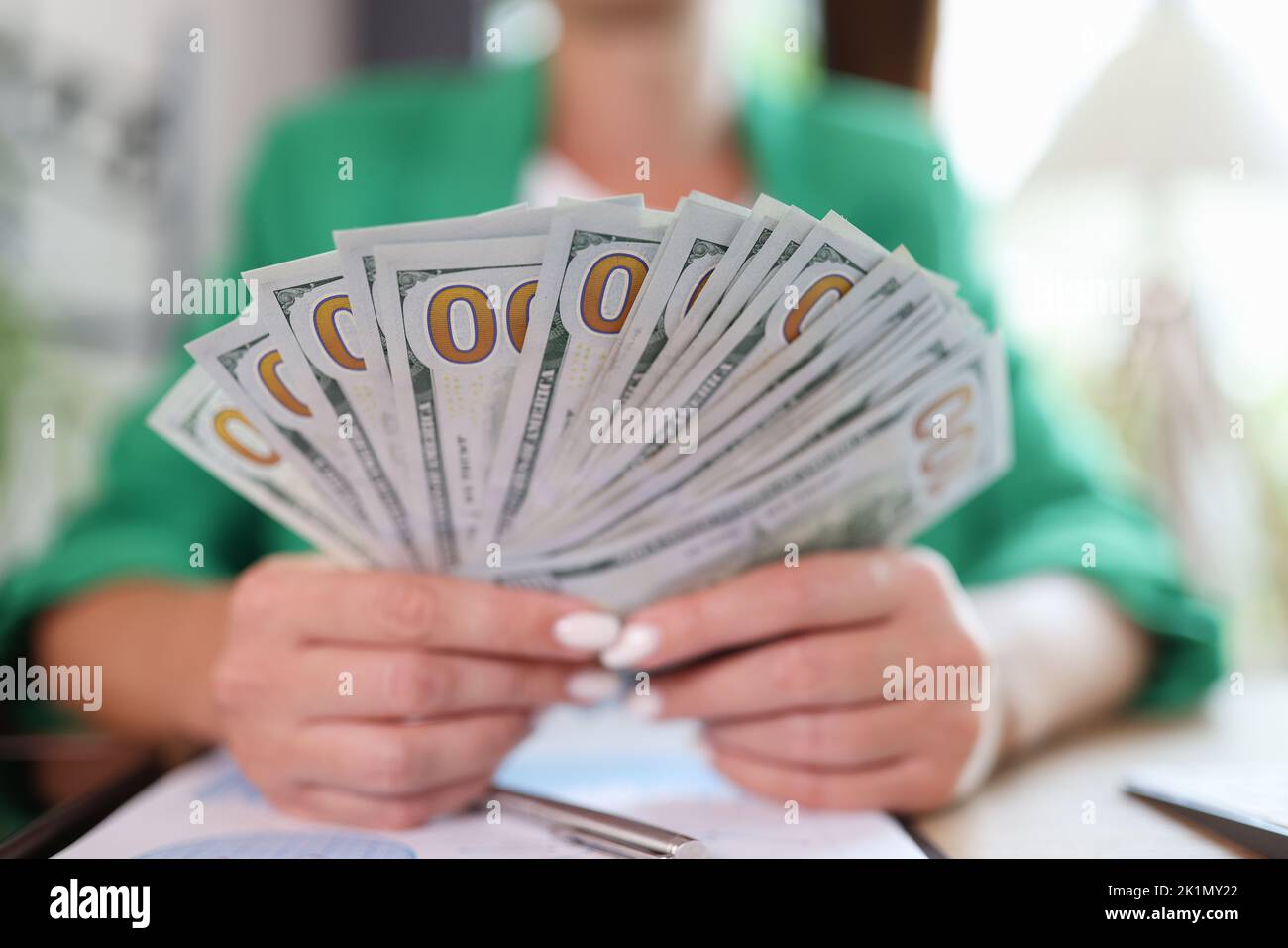 Business woman holding fan of dollars and financial income Stock Photo ...