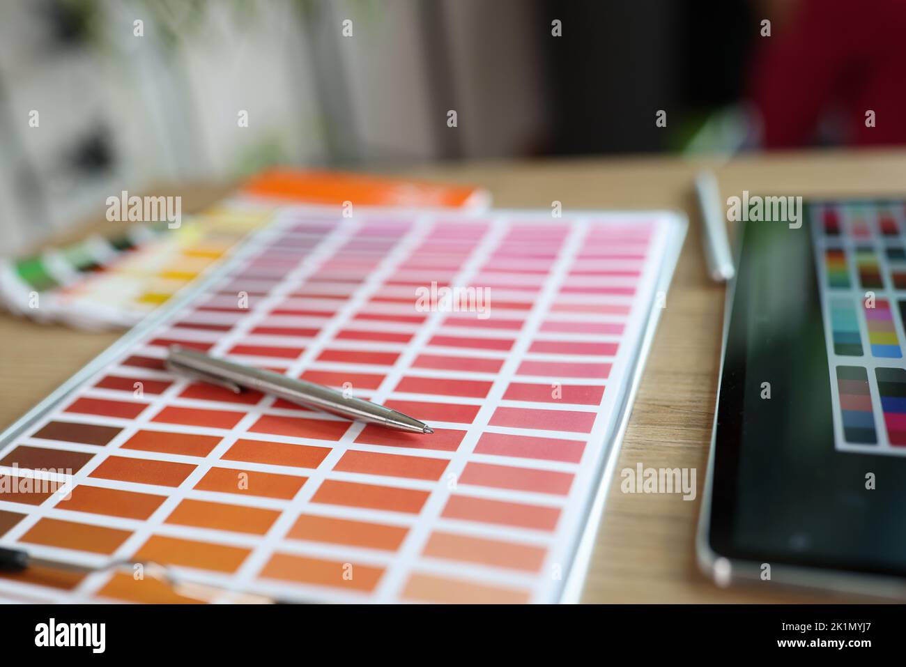 Color palette with different shades and tablet on table Stock Photo - Alamy
