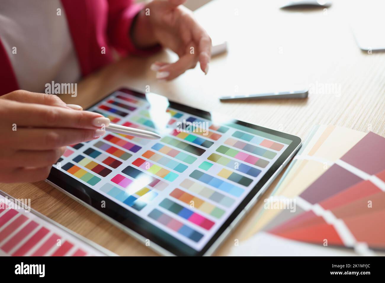Woman working with color palette and tablet in office Stock Photo - Alamy