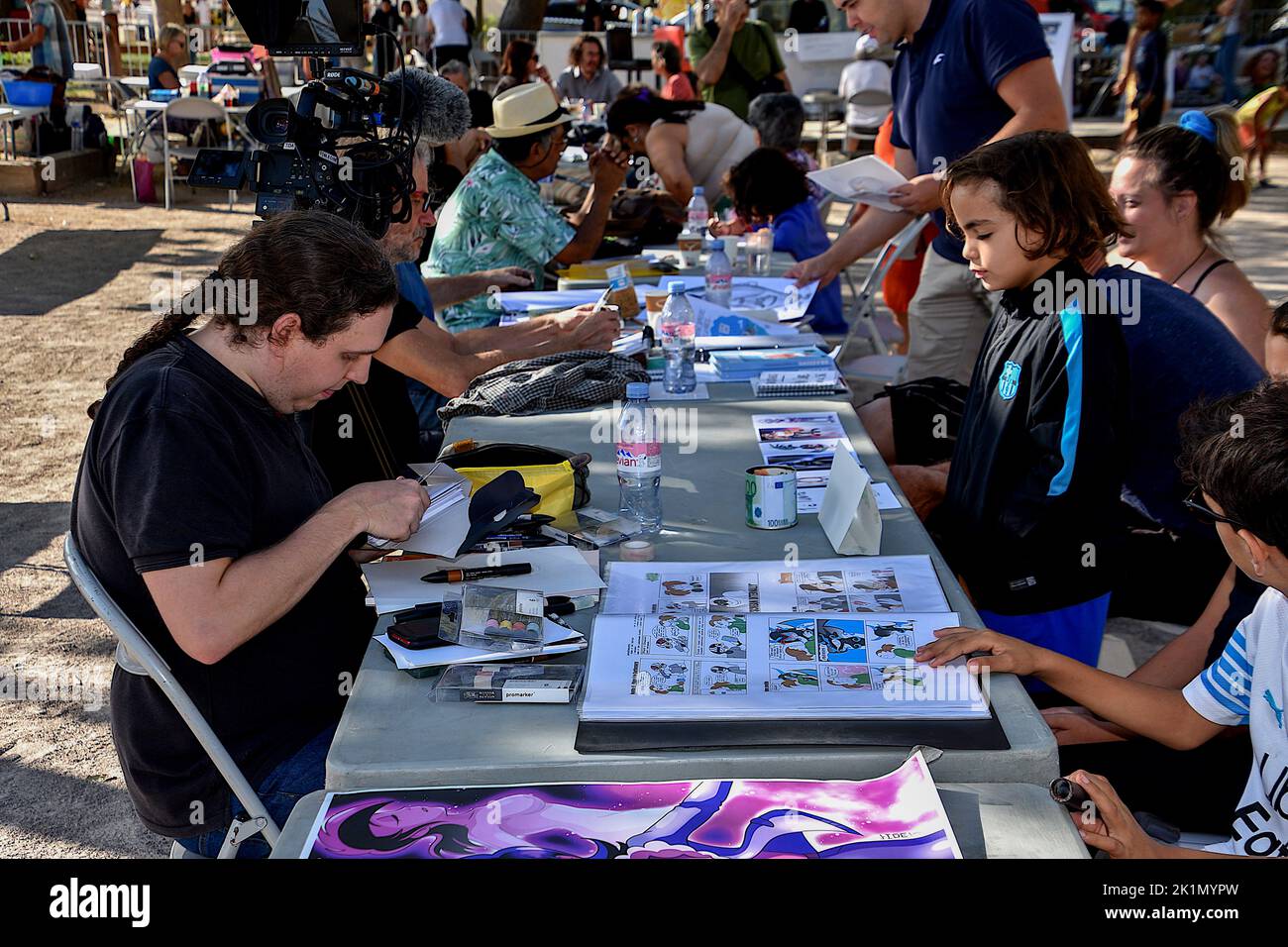 Cartoonists and caricaturists sketch the visitors during the festival ...