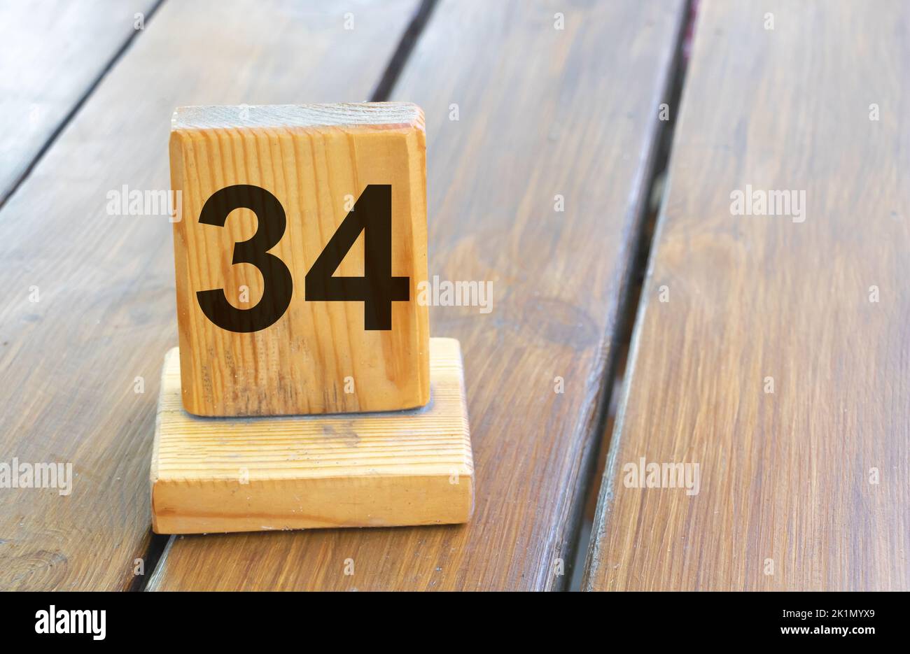 Wooden priority number 34 on a plank tab Stock Photo - Alamy