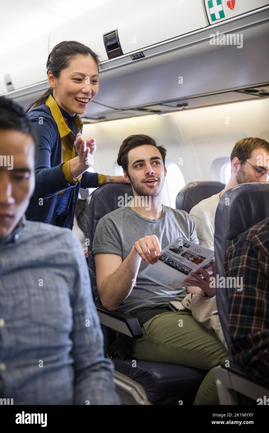 Flight attendant and passenger hi-res stock photography and images - Alamy