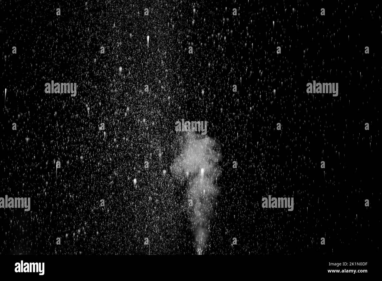 Curly white steam rising up and splashing water scattering in different ...