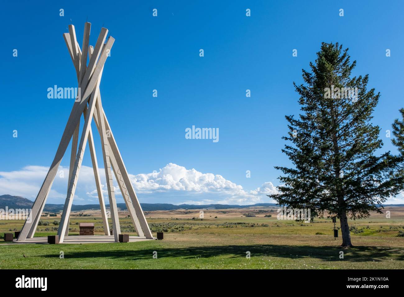 Sculpture of an indian tipi sits on the green grass at a wayside in ...
