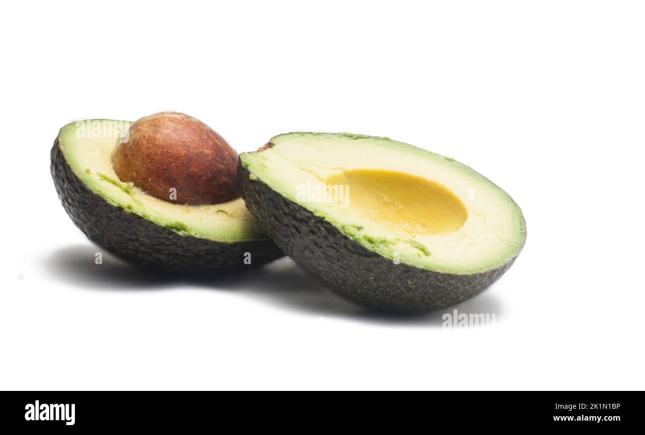 Cut open avocado one white background Stock Photo - Alamy