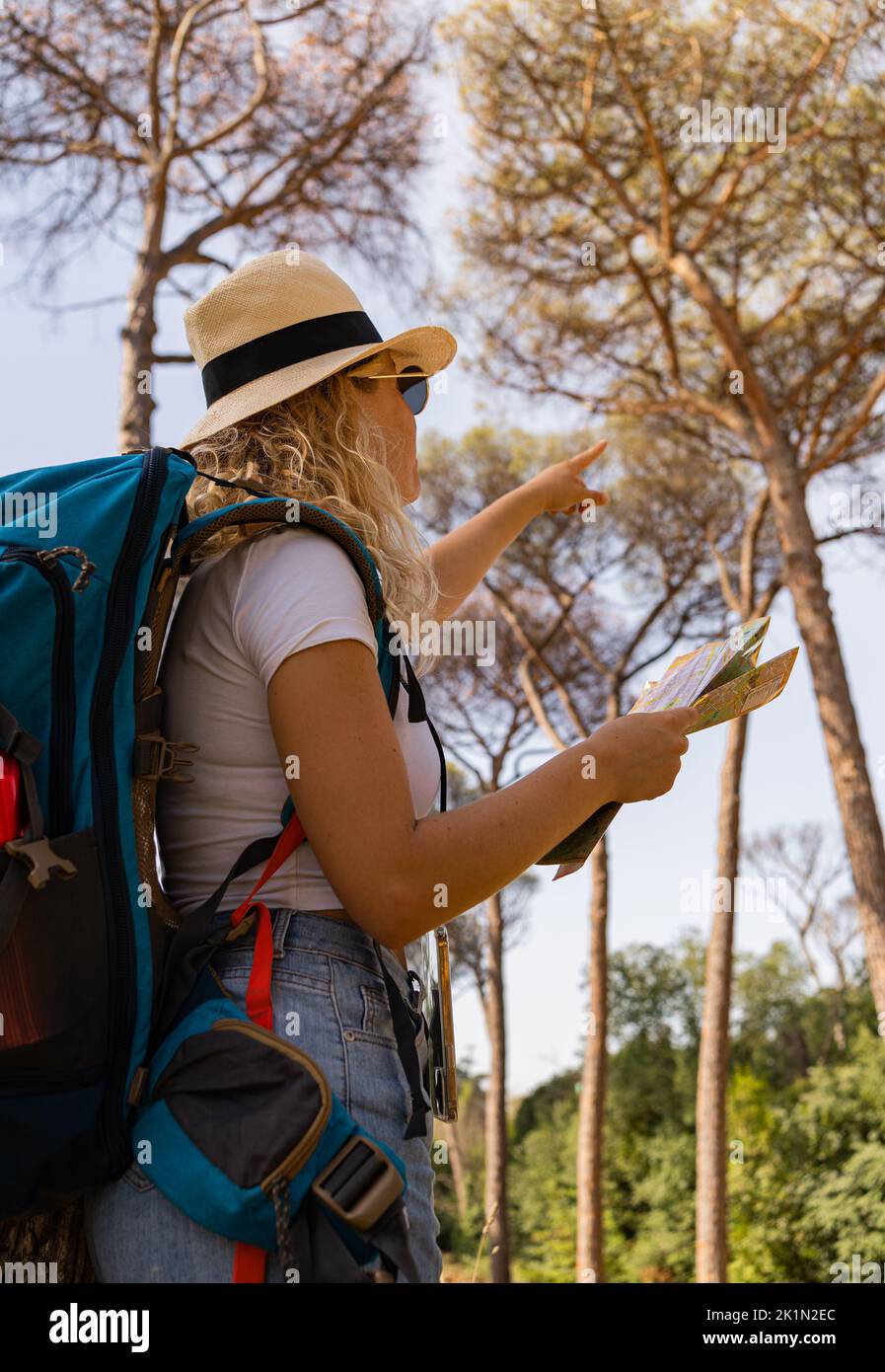 Brave woman explores with her map in the middle of the savannah ...