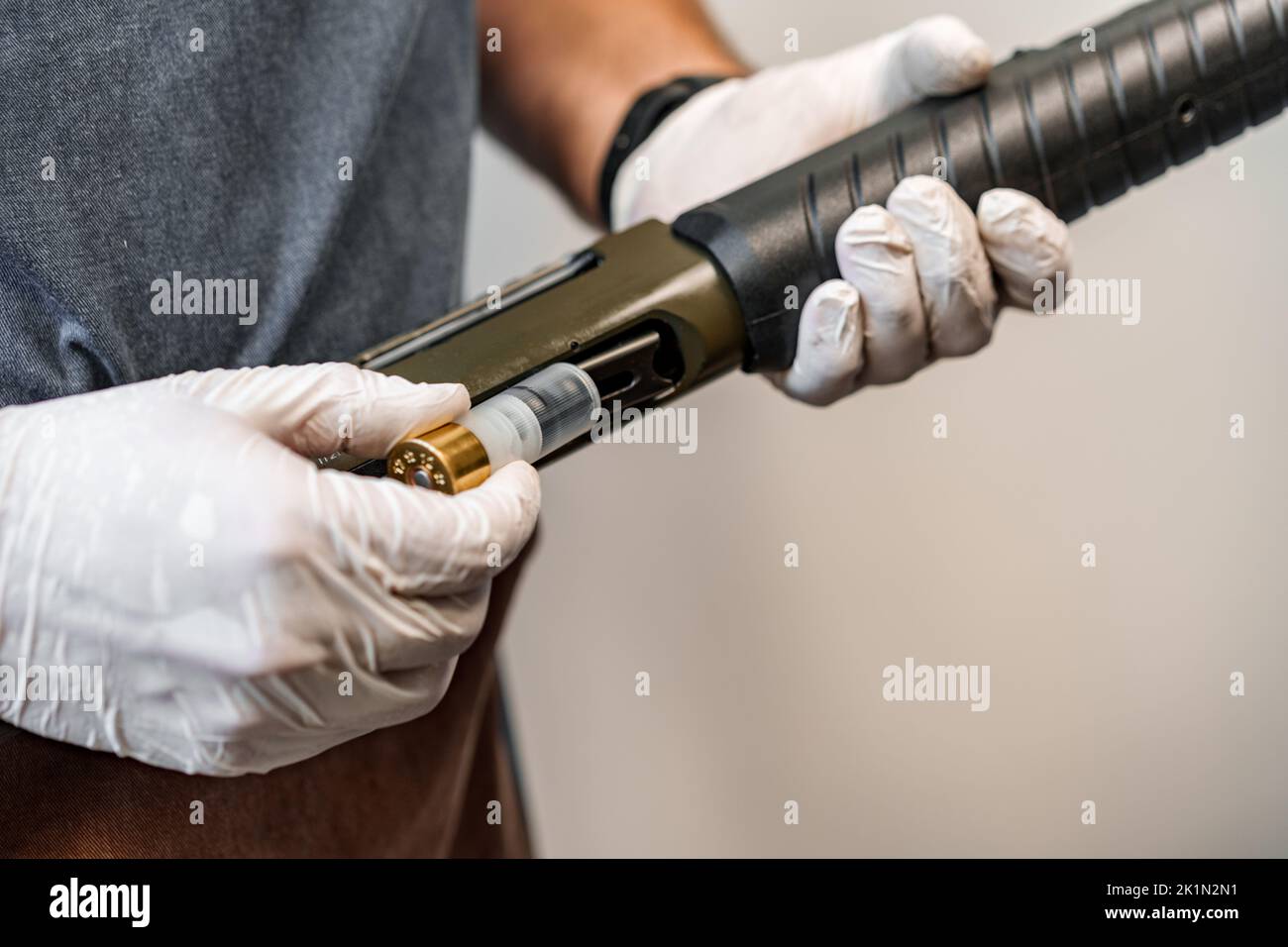 The gunsmith maintaining his rifle in a workshop Stock Photo - Alamy