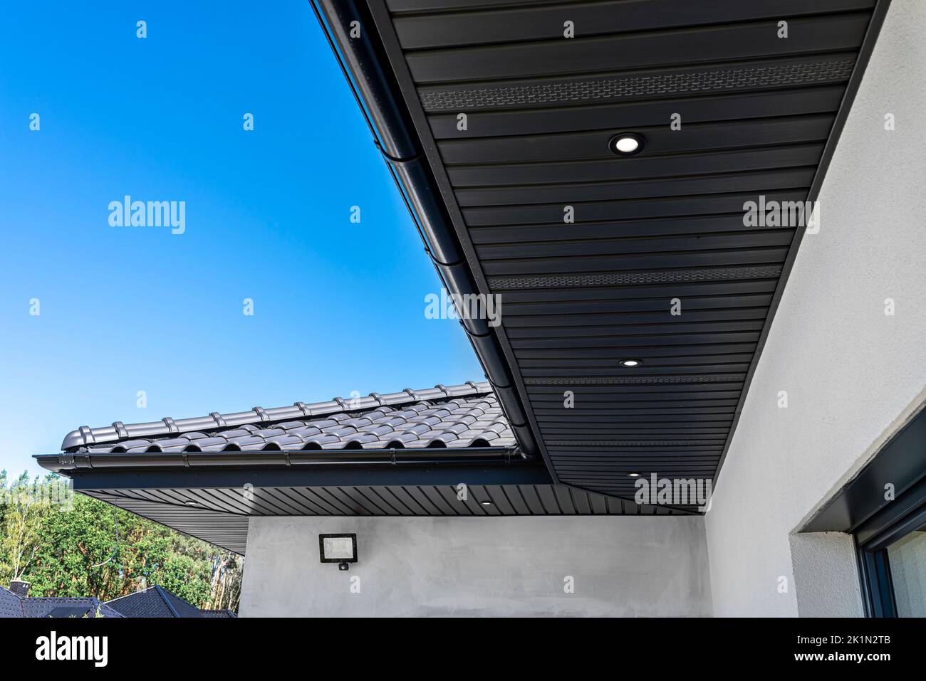 A modern graphite herringbone roof lining is attached to the trusses ...