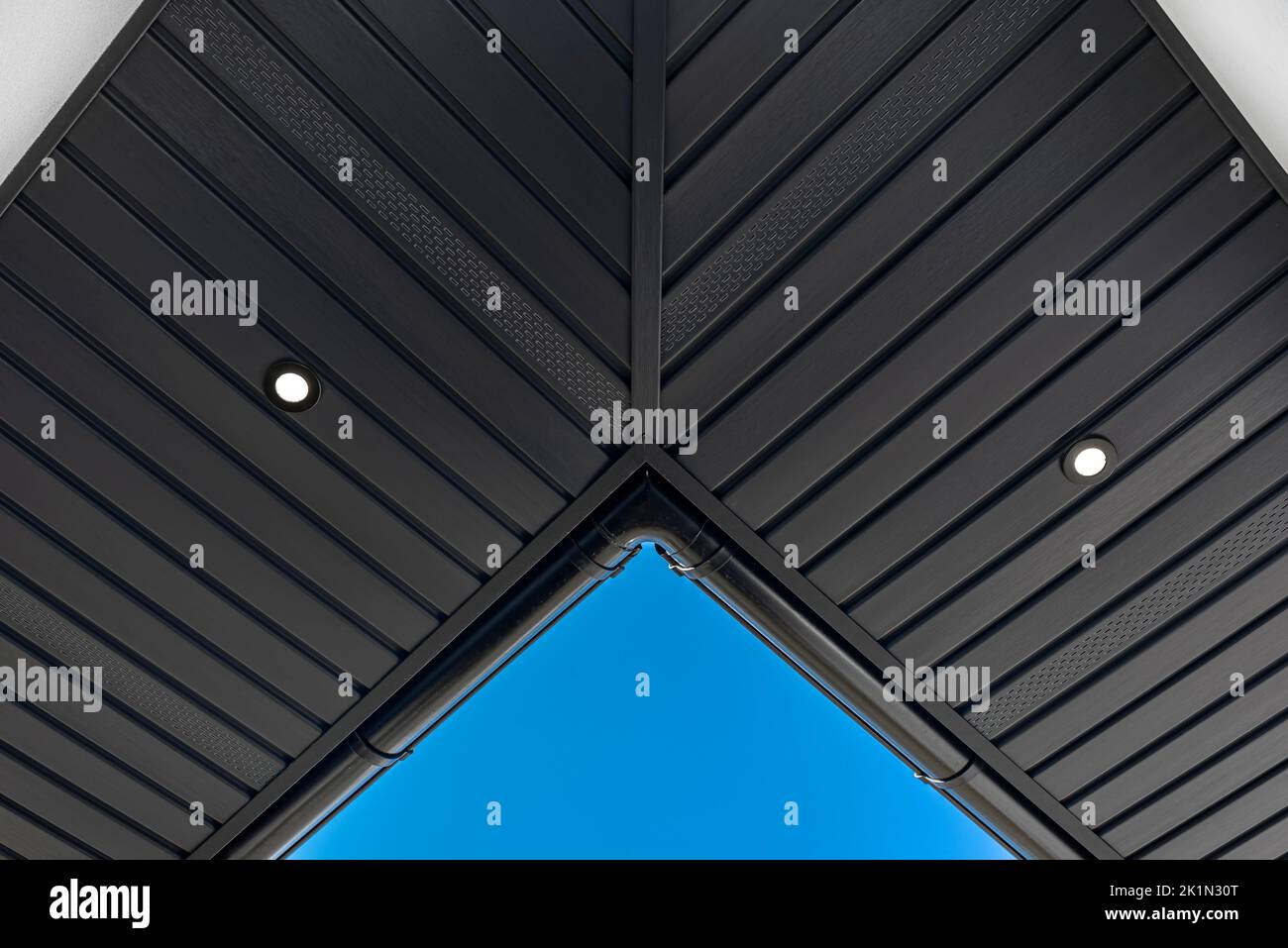 A modern graphite herringbone roof lining is attached to the trusses ...