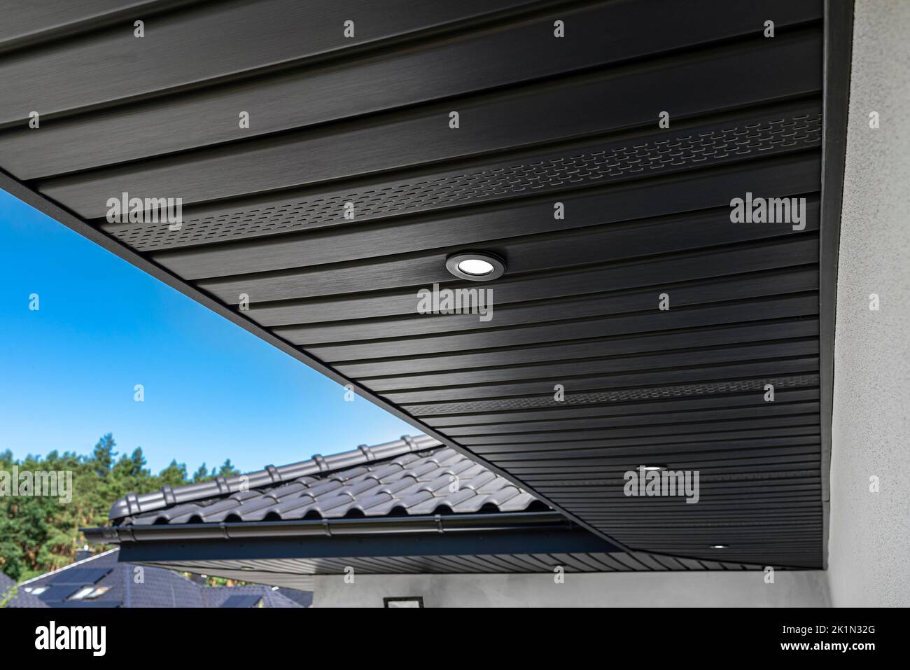 A modern graphite roof lining is attached to the trusses, visible ...