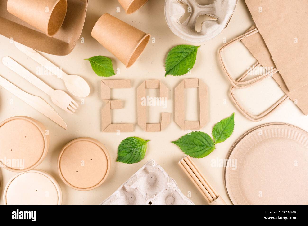 Paper utensils bundle, wooden cutlery set and paper word ECO over light ...