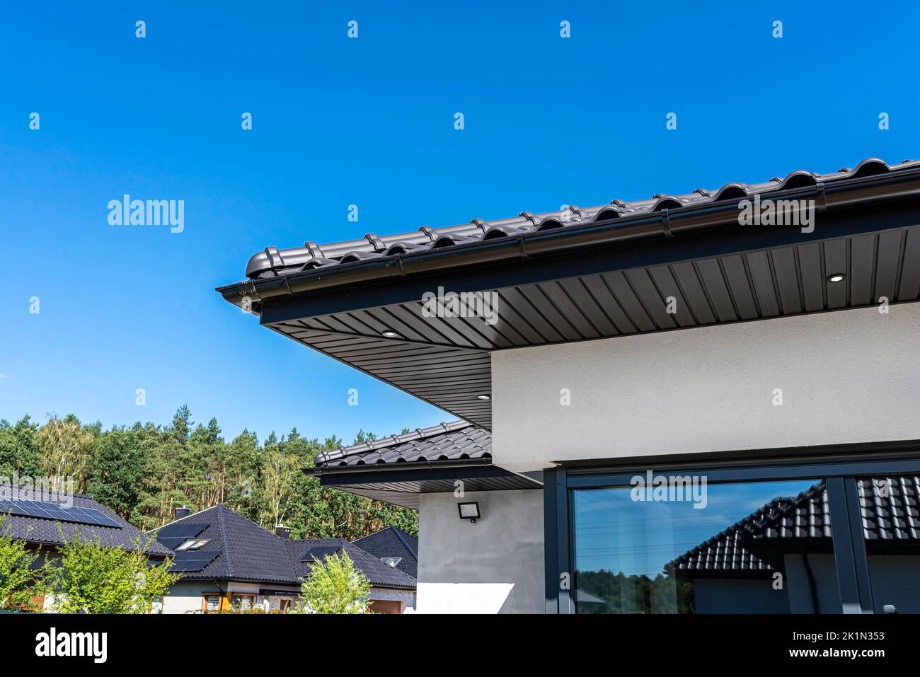 A modern graphite herringbone roof lining is attached to the trusses ...