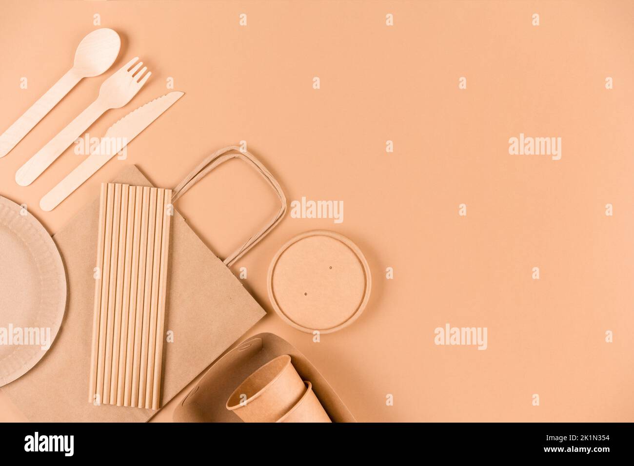 Ecology tableware - paper food packaging over light brown background ...