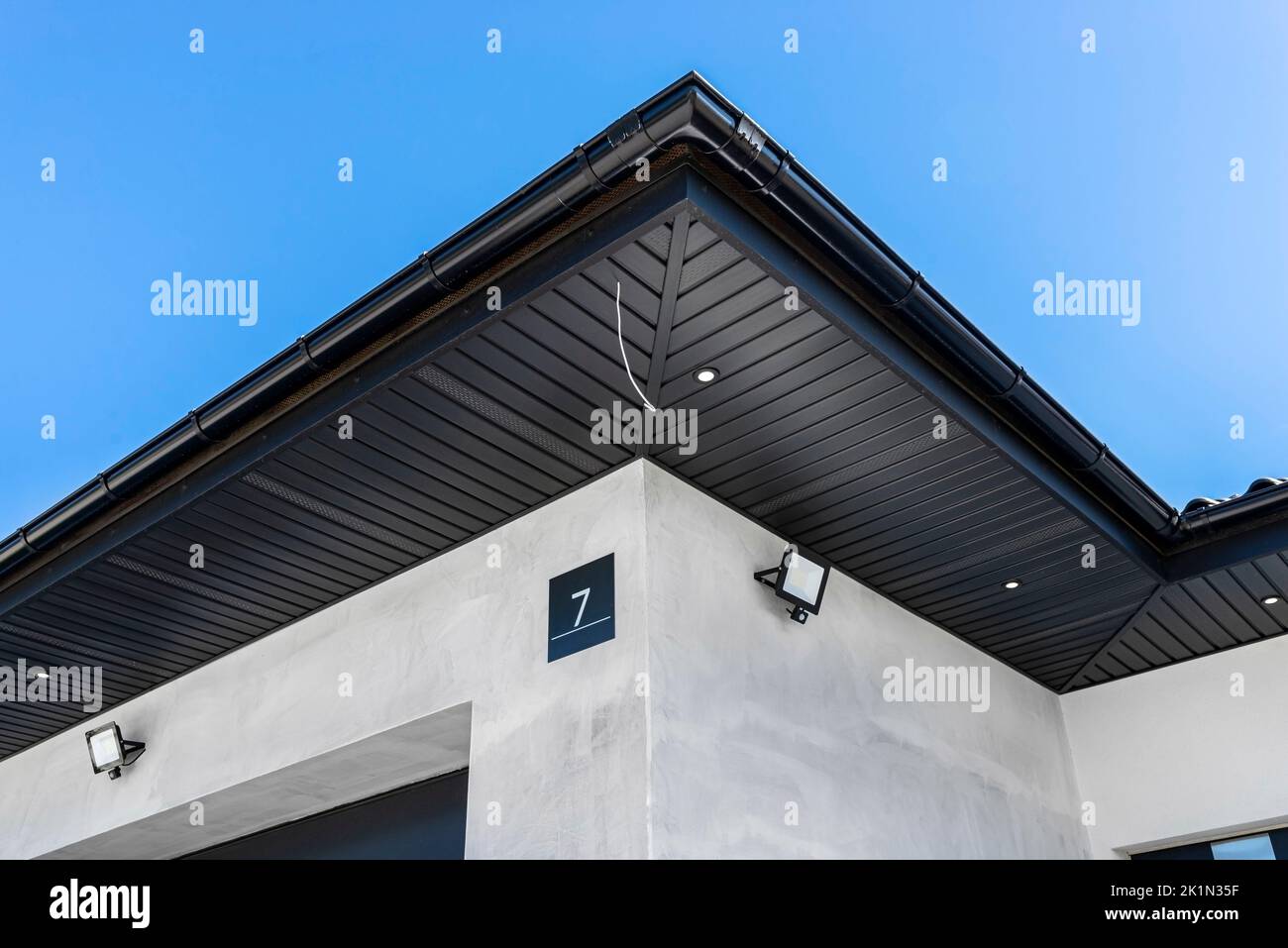 A modern graphite herringbone roof lining is attached to the trusses ...