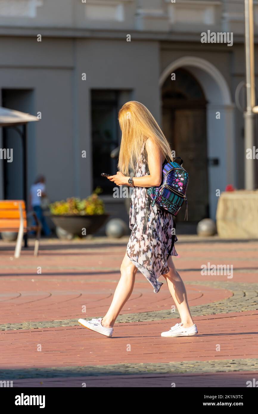 Woman walking on the street. Real people Stock Photo - Alamy