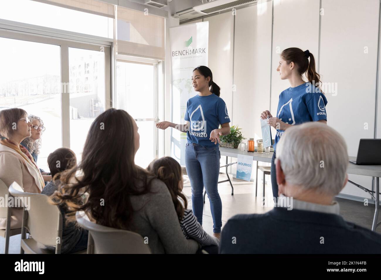 Female environmentalists speaking to audience in community center Stock ...