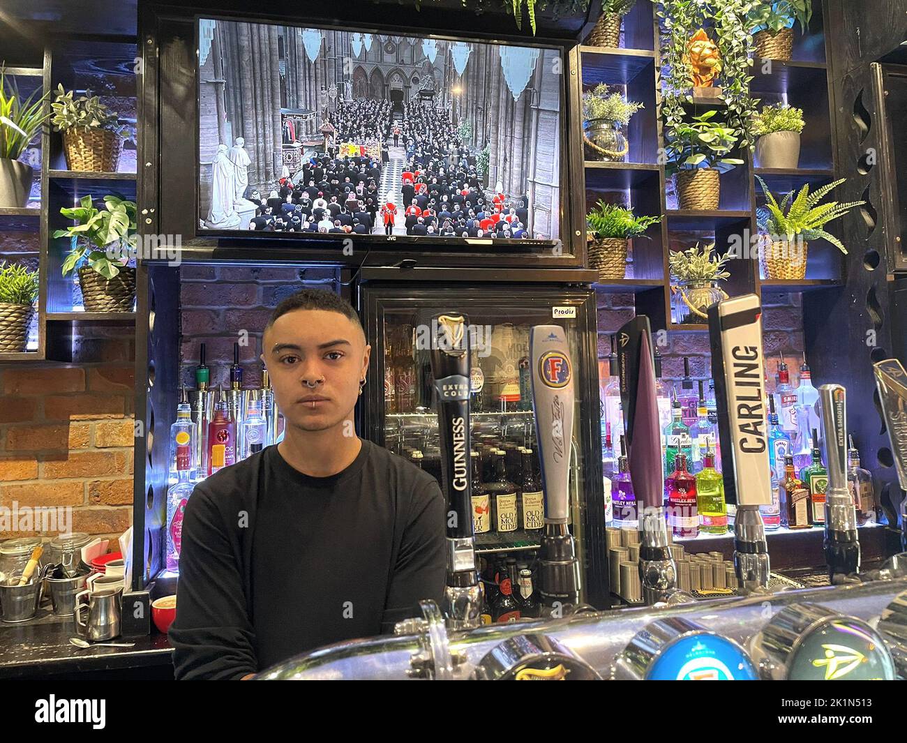 Bartender Xaviar Morgan-Roe, 19, watching the State Funeral of Queen ...