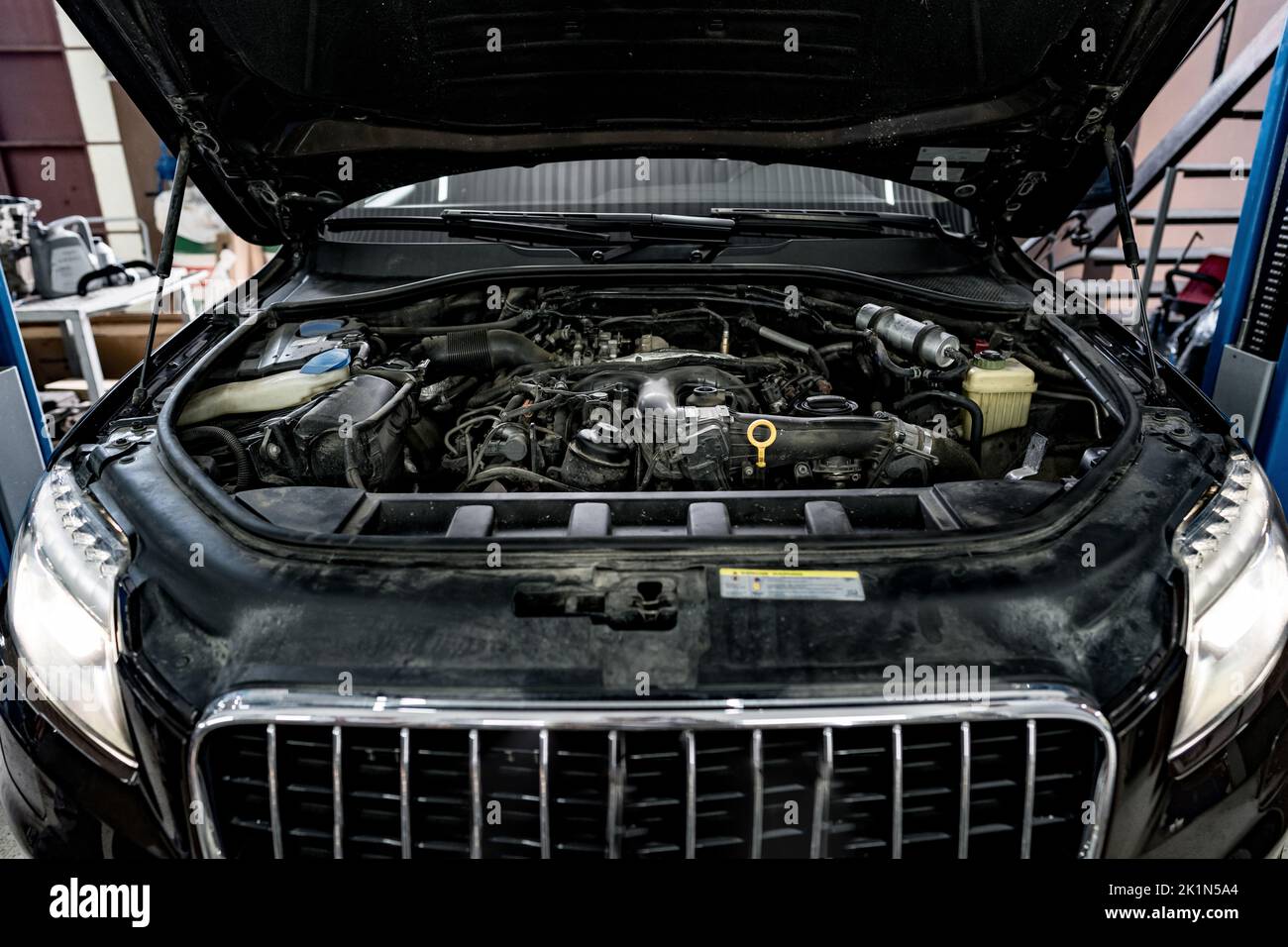 View of engine and other parts under the open hood of a car Stock Photo ...