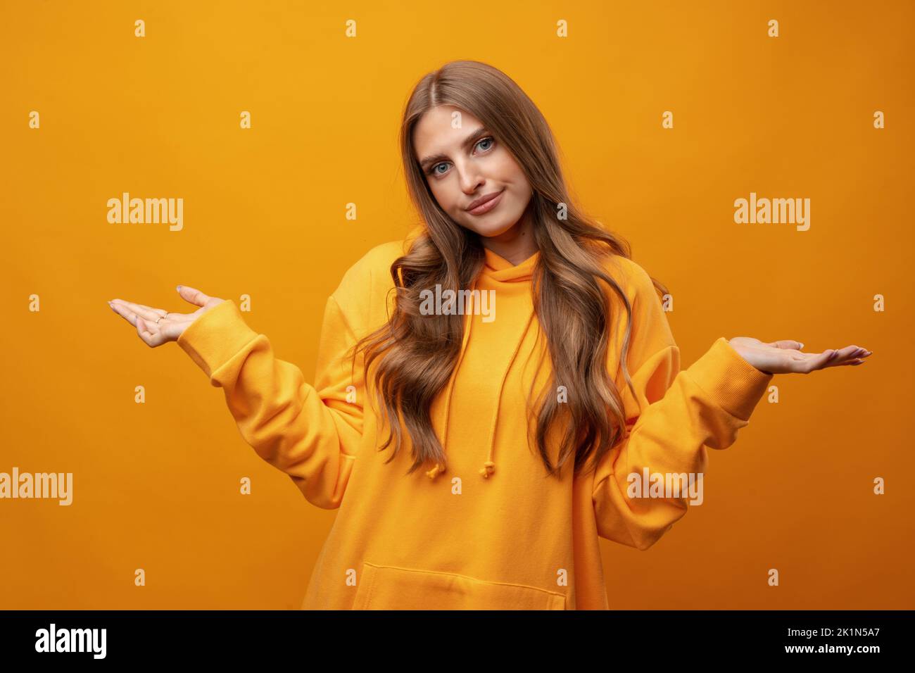 Portrait of cute attractive young woman showing whatever gesture on ...