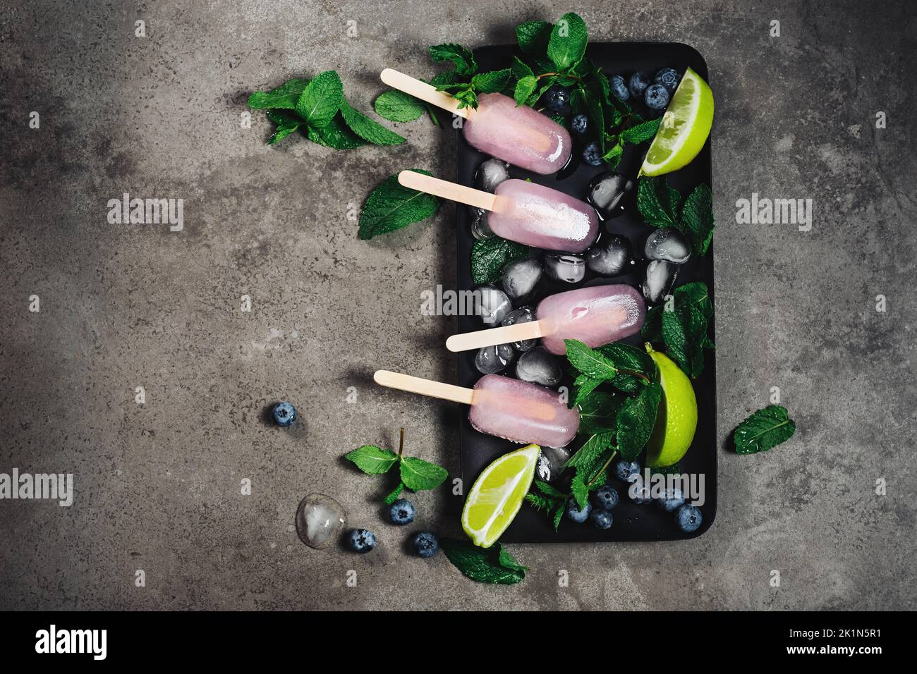 Blueberry mojito popsicles. Refreshing frozen cocktail, top view, copy ...