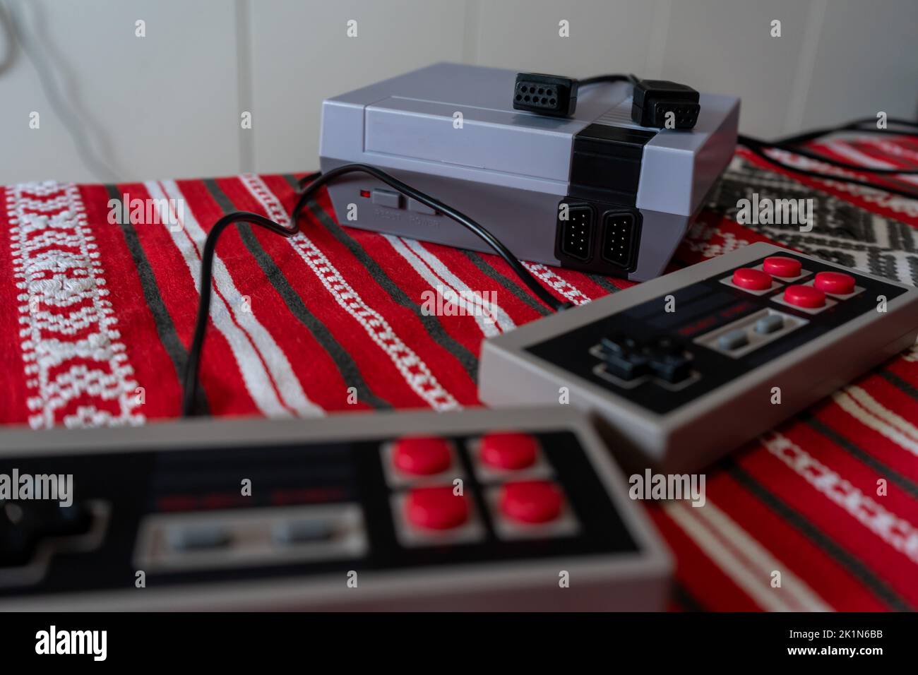 Retro gaming console with classic gamepad controller on a table Stock ...