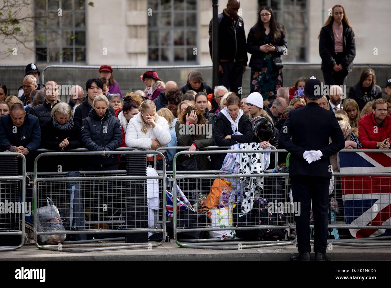 Mourners seen crying during the 2 minutes of silence after the state ...