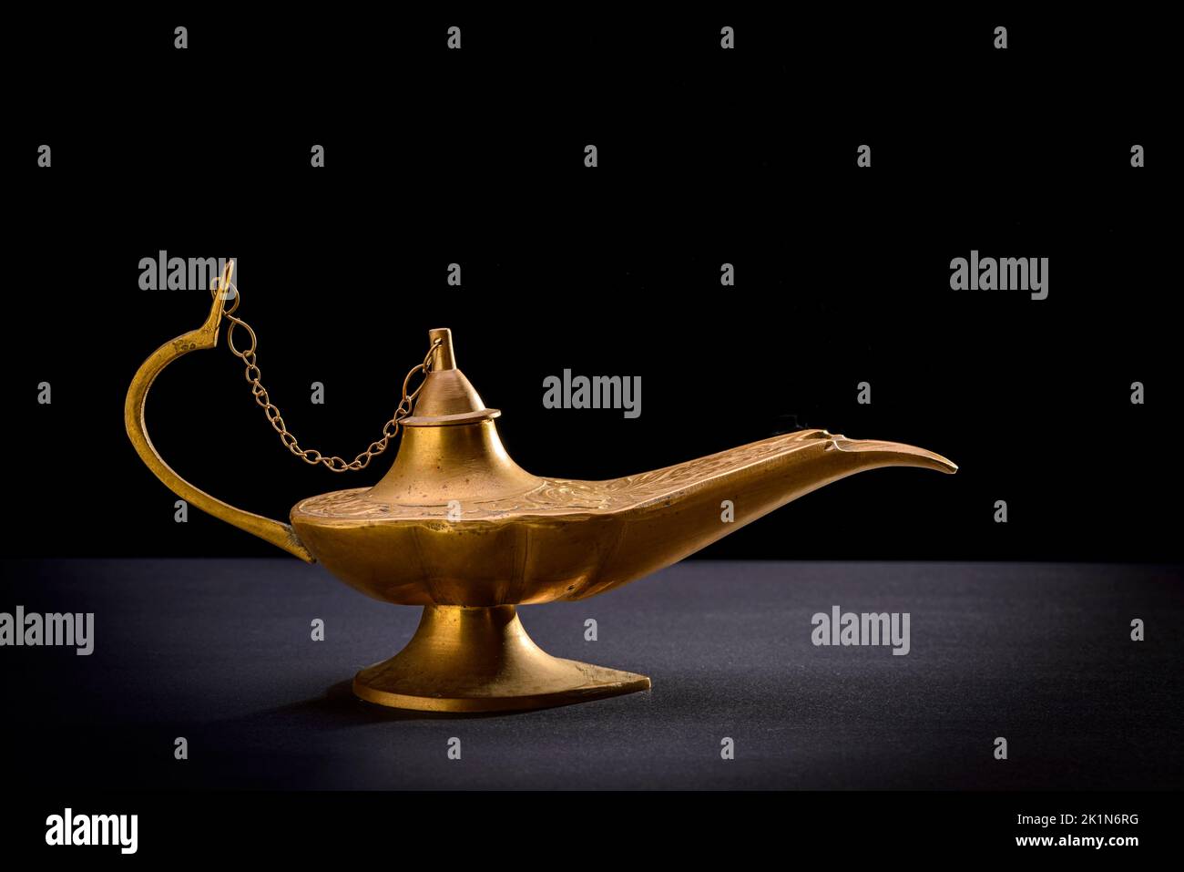 Aladdin's magic lamp isolated on black background Stock Photo - Alamy