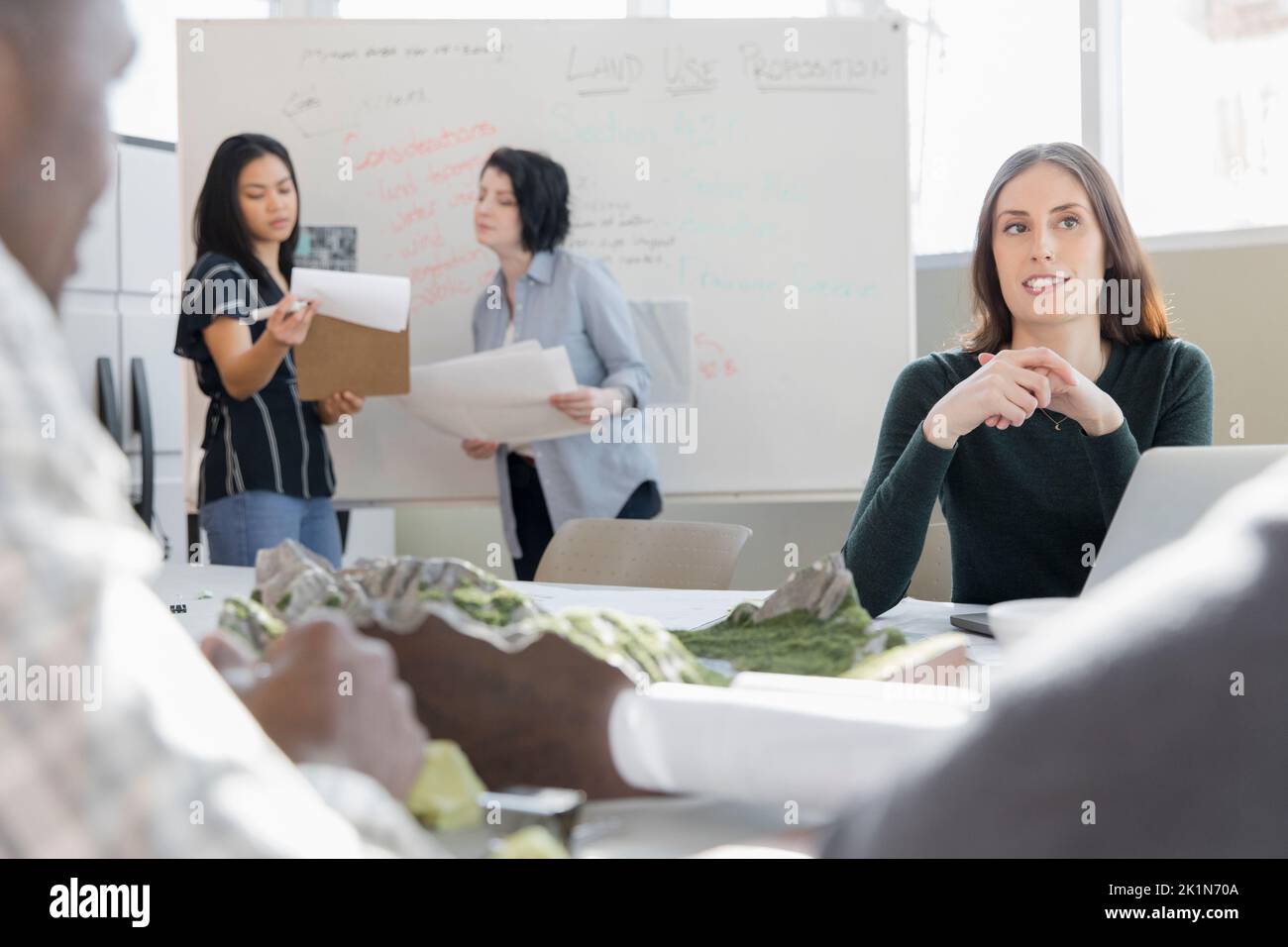 Land use planners talking in community center meeting Stock Photo - Alamy