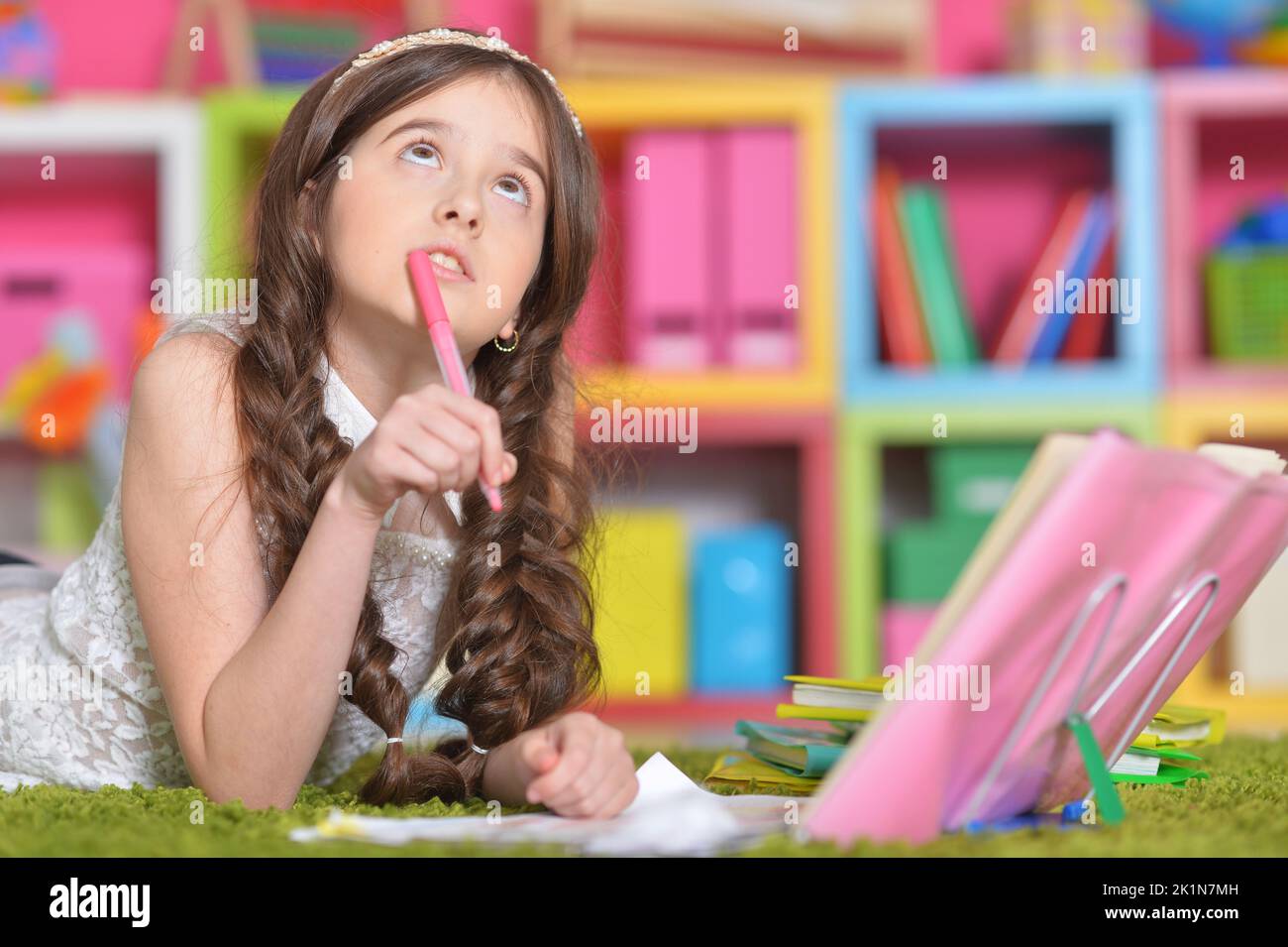 Portrait of cute little girl study at home Stock Photo - Alamy
