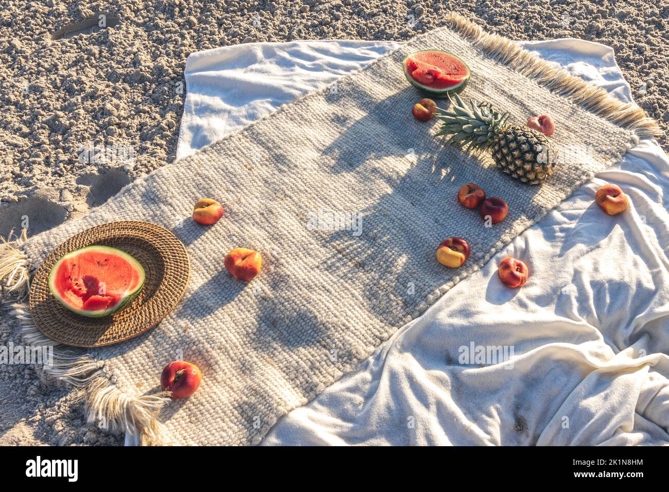 Blanket with fruits on sandy beach, picnic concept Stock Photo - Alamy