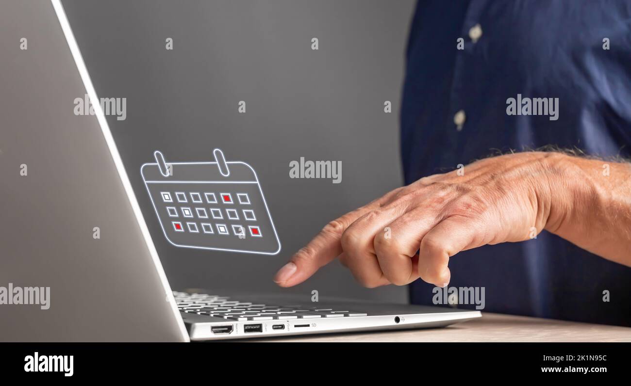 Man looking at calendar on laptop. Forefinger at keyboard closeup. Work ...