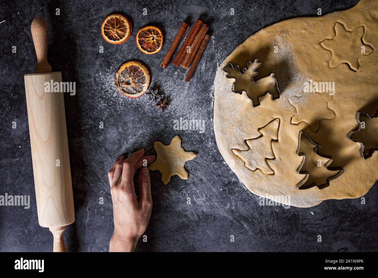 Female hands, rolling pin, flour, shapes for gingerbread, dough and ...