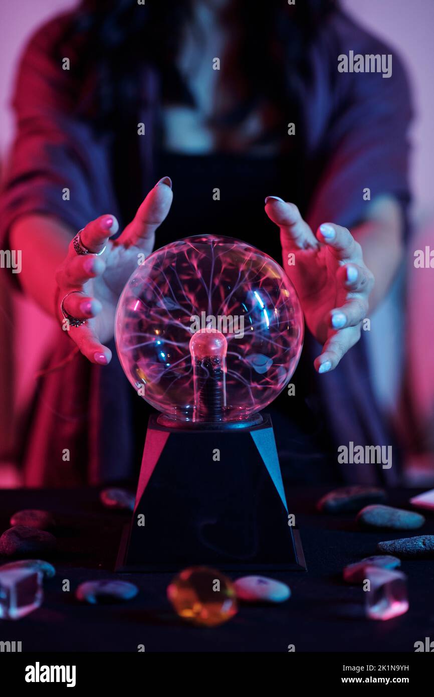 Closeup image of fortune teller gazing into crystal ball and seeing ...