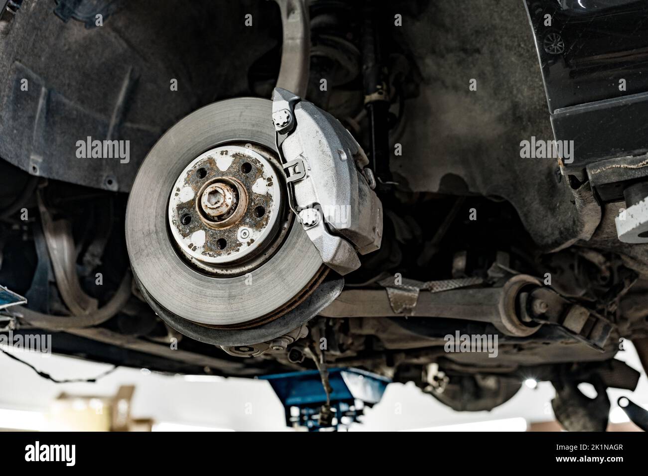 Steel brake disc with pad in car service Stock Photo - Alamy