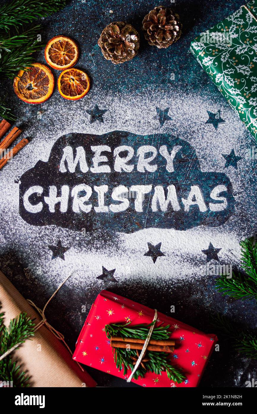 Handmade inscription Merry Christmas from flour on dark background with ...