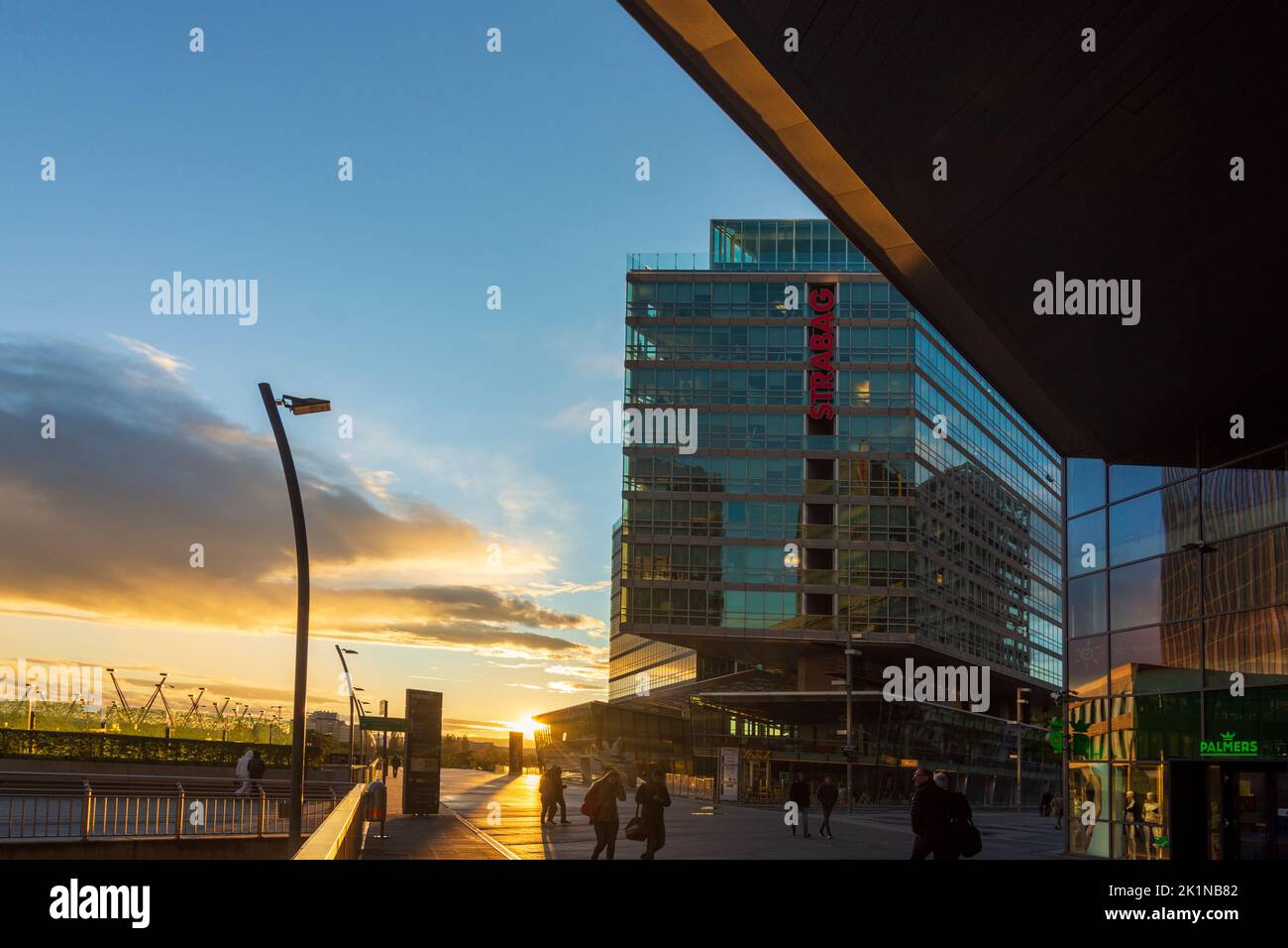 Wien, Vienna: Strabag Headquarters in Donaucity, pedestrians at sunset ...