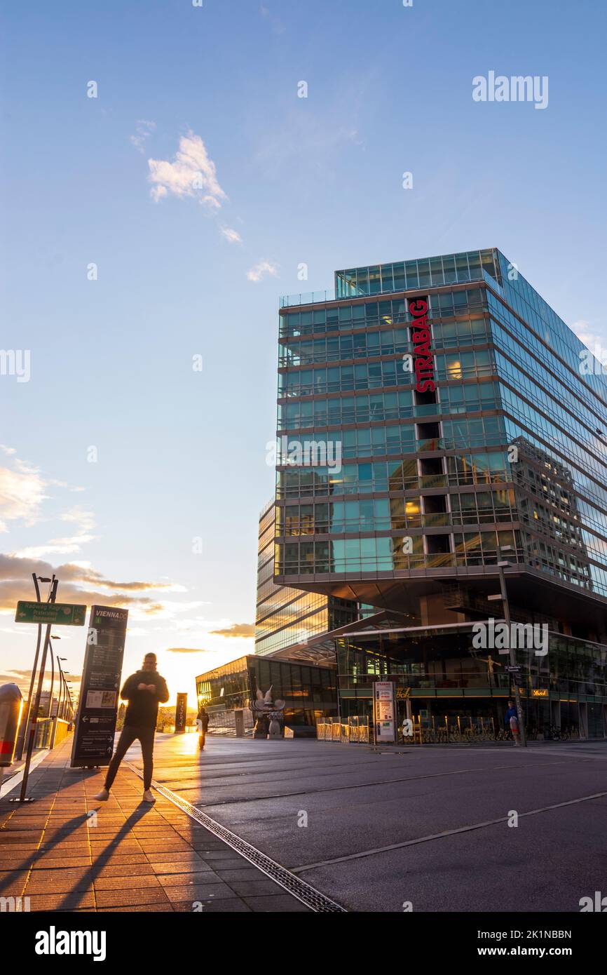 Wien, Vienna: Strabag Headquarters in Donaucity, pedestrians at sunset ...