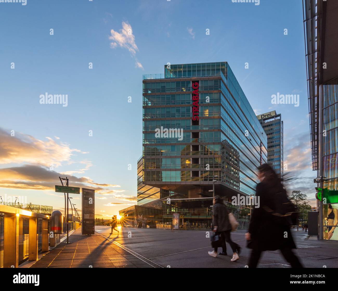 Wien, Vienna: Strabag Headquarters in Donaucity, pedestrians at sunset ...